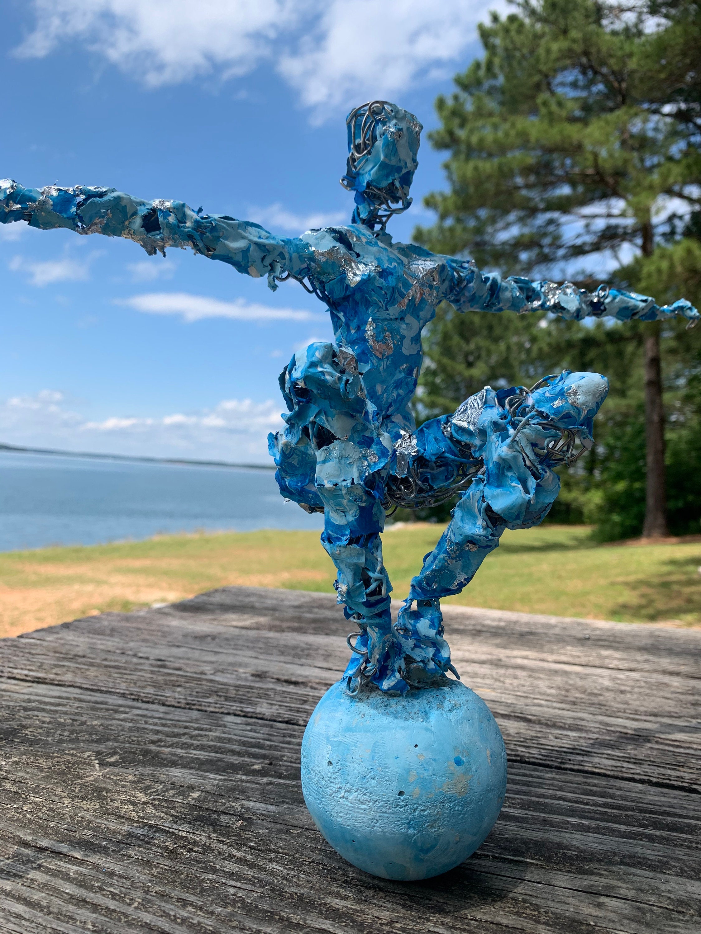 Light Blue and Silver Wire Art Sculpture on Cement Balancing on a Ball ...