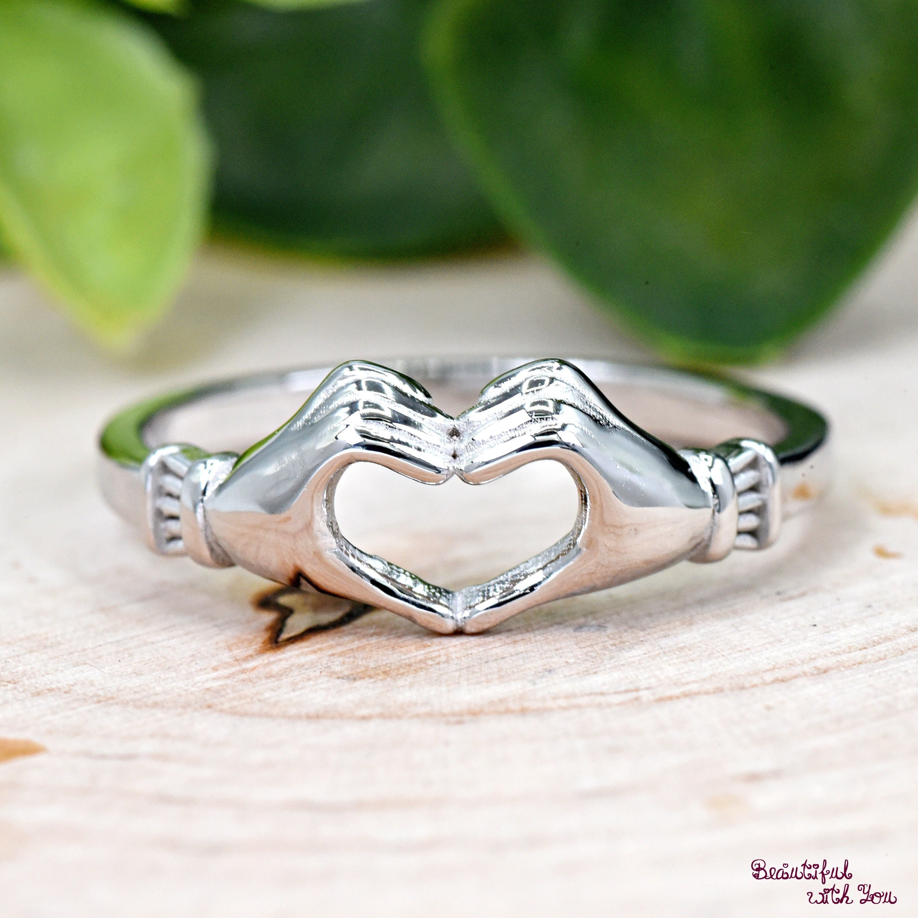 Two Hands Holding A Heart Ring