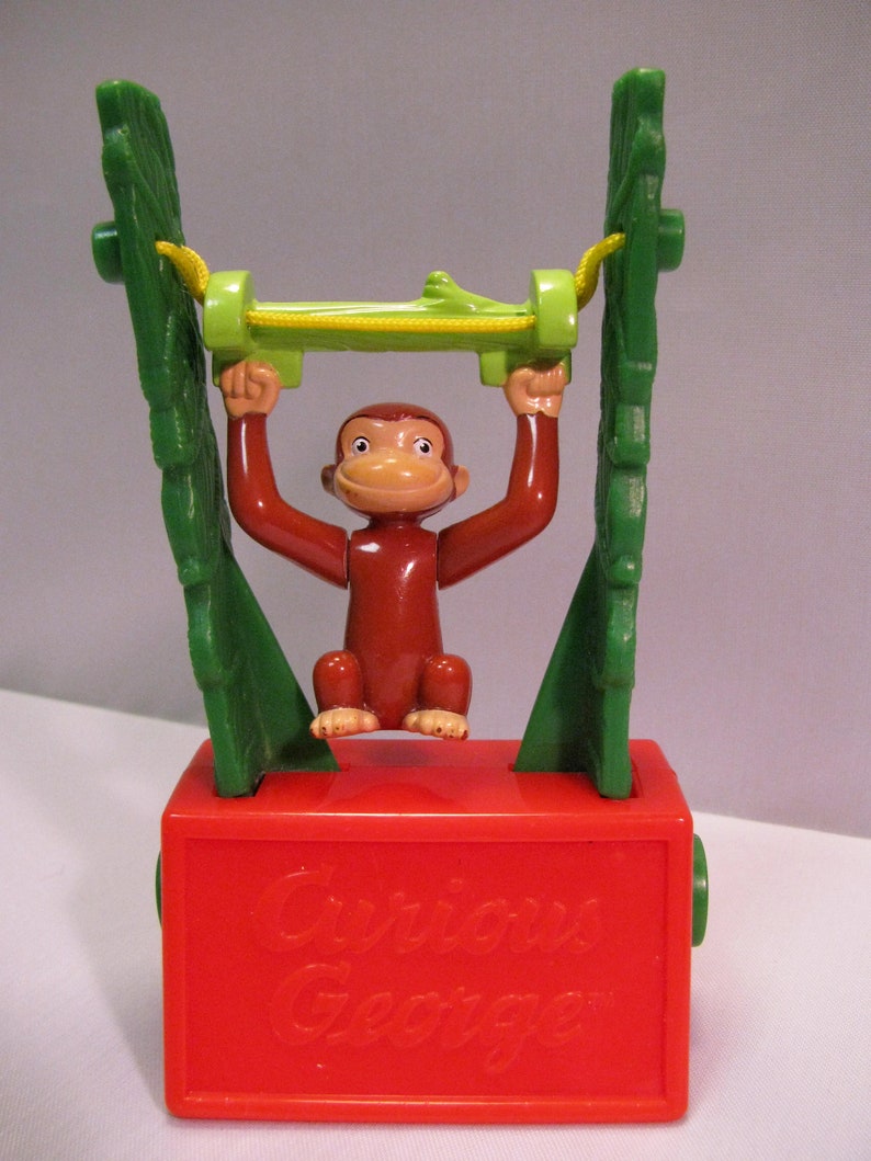 Vintage Curious George Flip Toy Handheld Small Red and Green Plastic ...