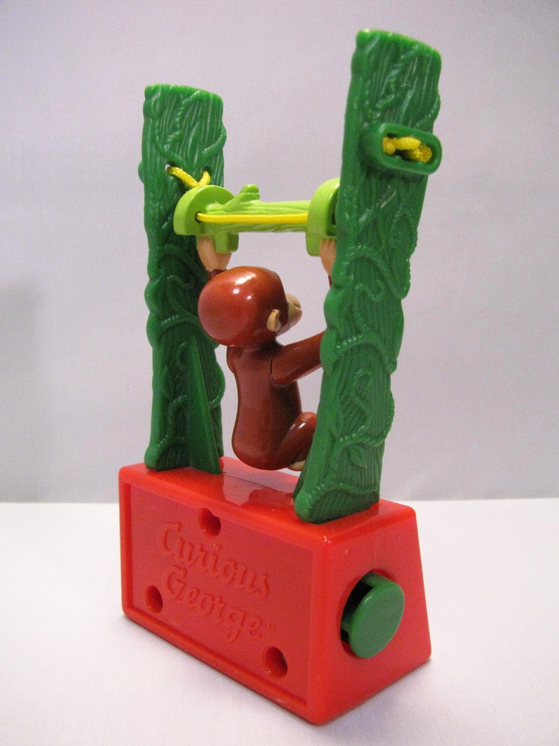 Vintage Curious George Flip Toy Handheld Small Red and Green Plastic ...