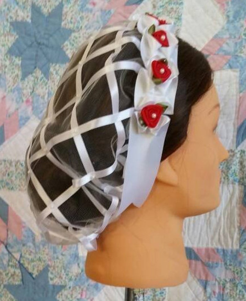 White Ribbon Hairnet With Red Satin Ribbon Roses on a White Folded ...