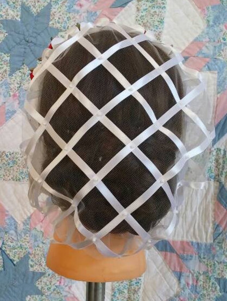 White Ribbon Hairnet With Red Satin Ribbon Roses on a White Folded ...