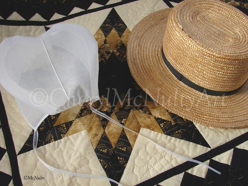 Amish Prayer Cap and Straw Hat on Amish Quilt Photographic Print Amish ...