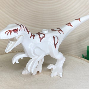 Dinosaur White Atrociraptor With Reddish Brown Markings and Red Eyes ...