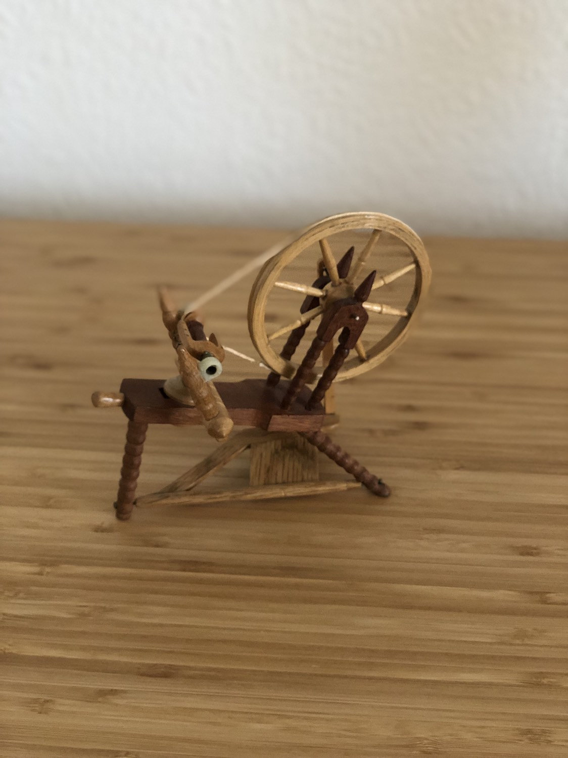 Miniature hand carved wooden spinning wheel with working wheel and pedal