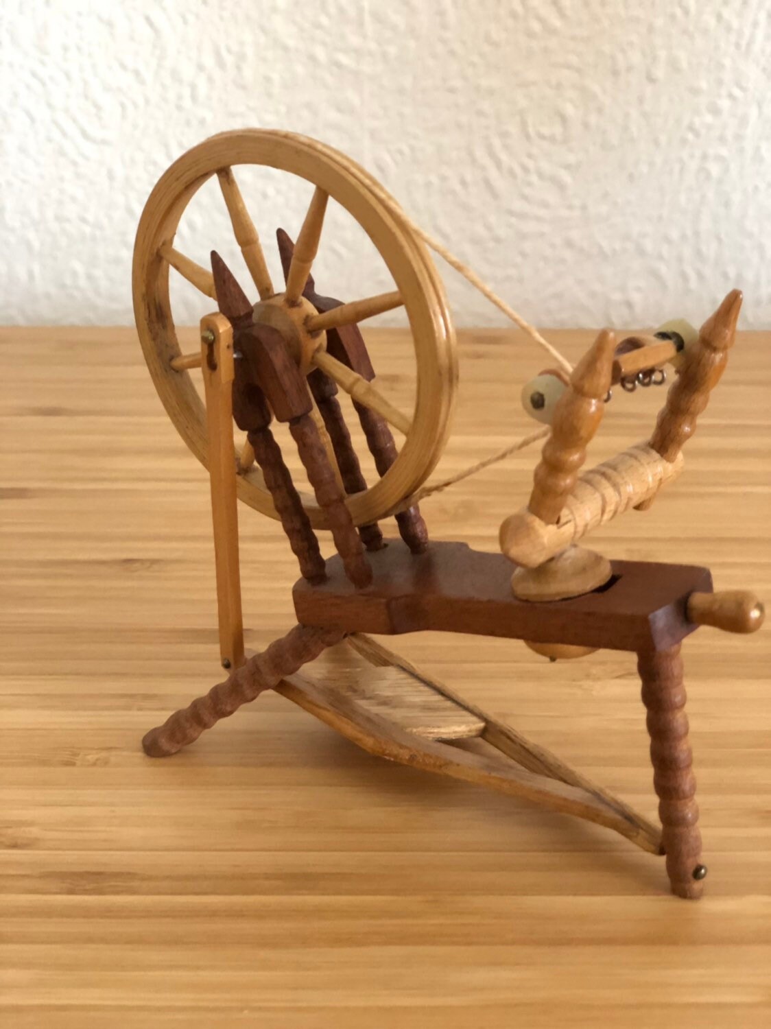 Miniature hand carved wooden spinning wheel with working wheel and pedal