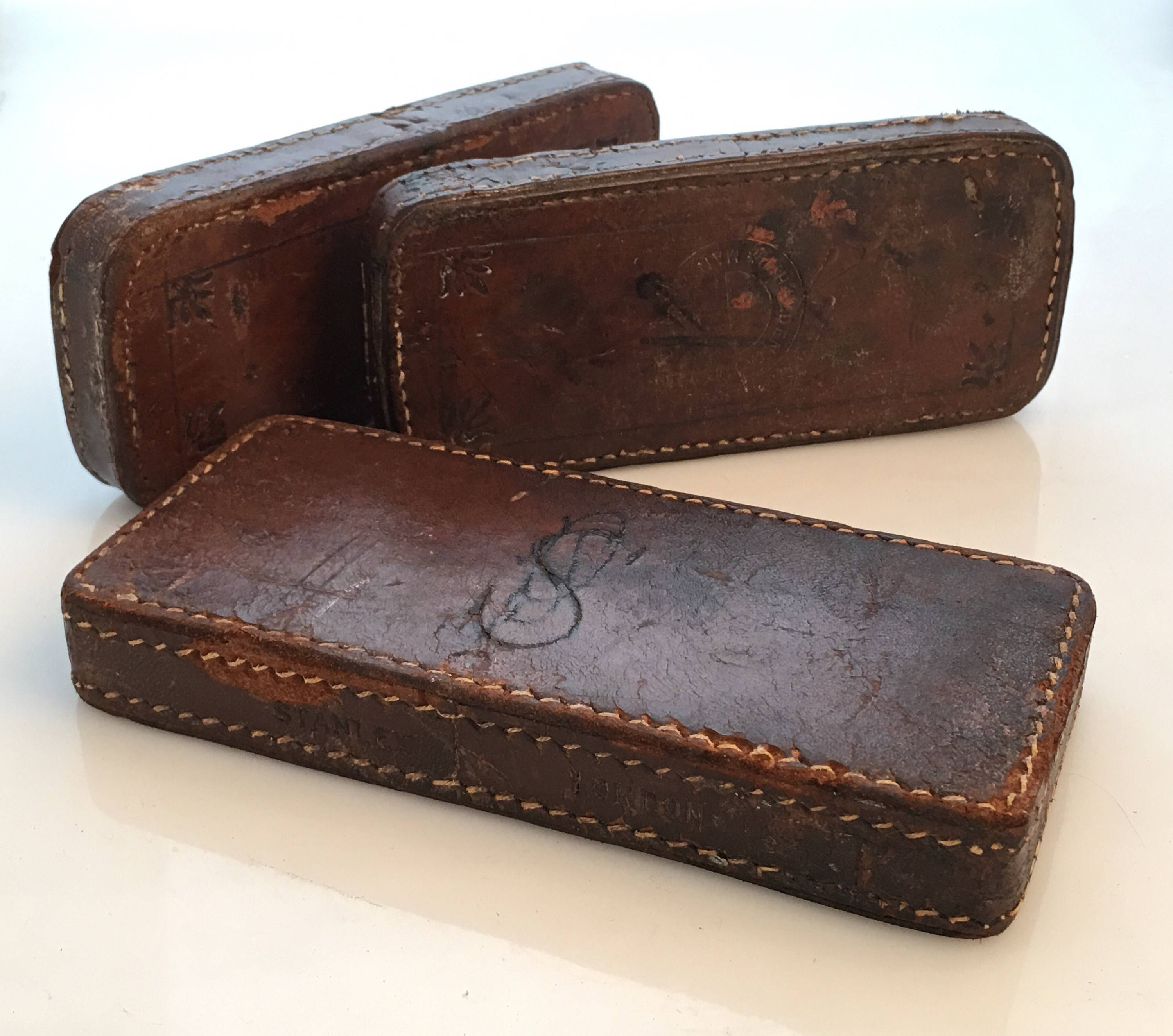Antique leatherbound lead map weights group of three