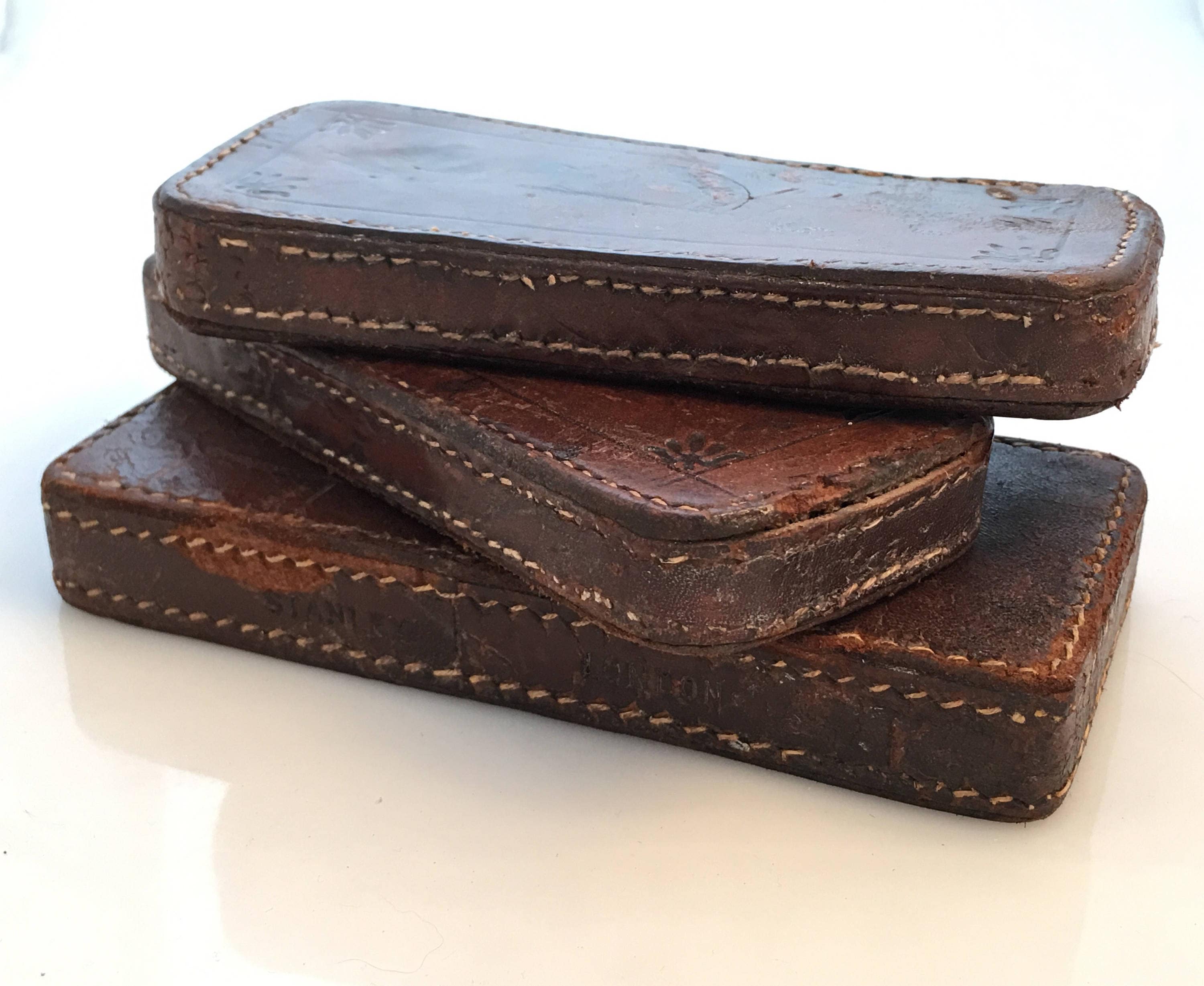 Antique leatherbound lead map weights group of three