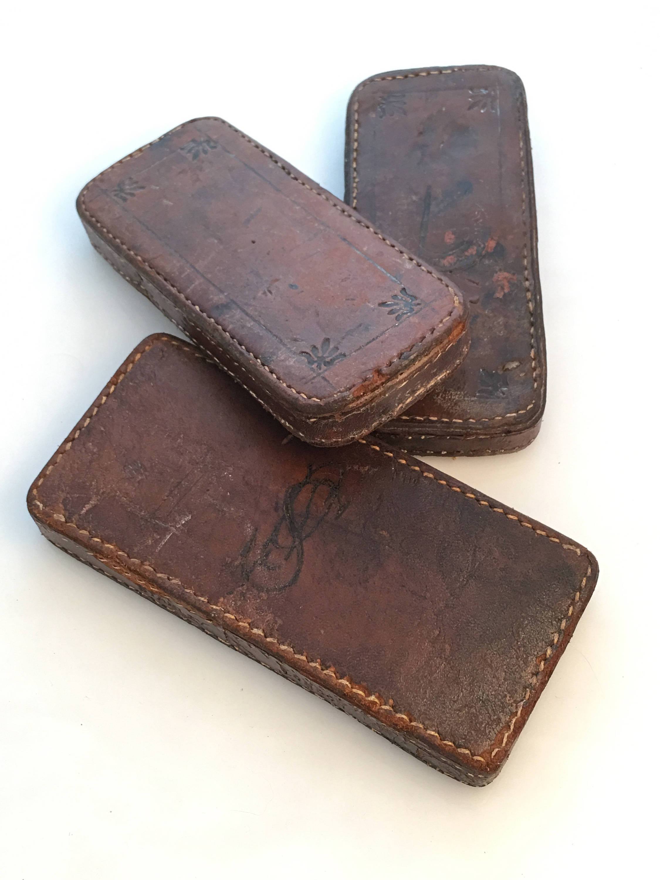 Antique leatherbound lead map weights group of three