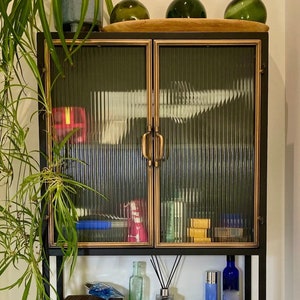 Black wall cabinet with glass doors store