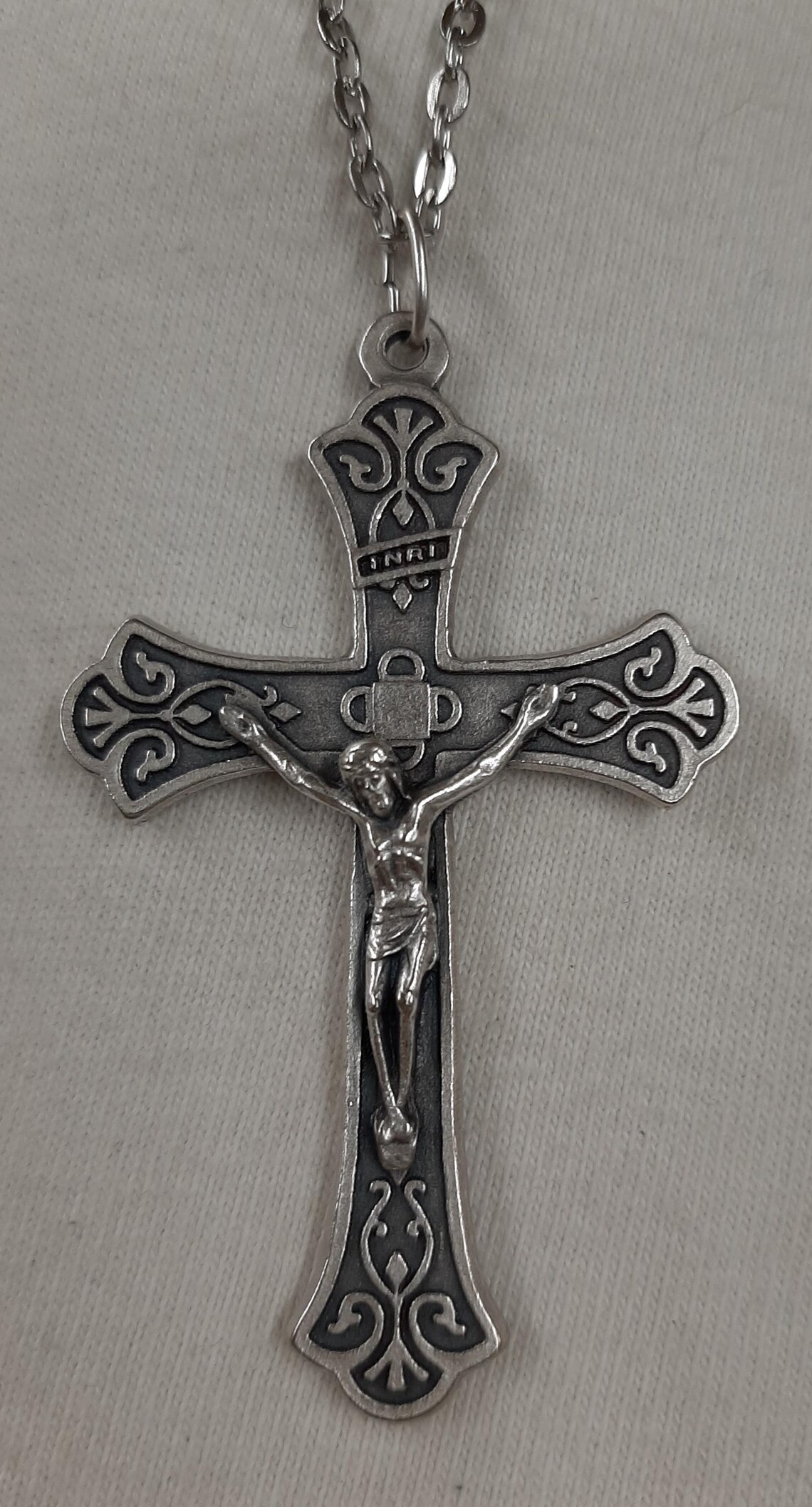 Handsome Fleur De Lis Swirl Accented Scalloped Arm Silvertone Crucifix ...