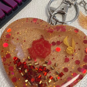 Red and Gold Liquid Shaker Heart Resin Keychain With H.P. Brave House ...