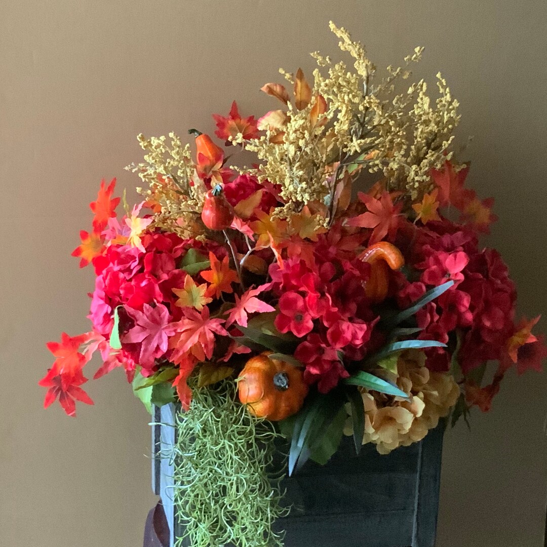 Red Geraniums With Orange and Red Autumn Leaves With Red Geraniums and ...
