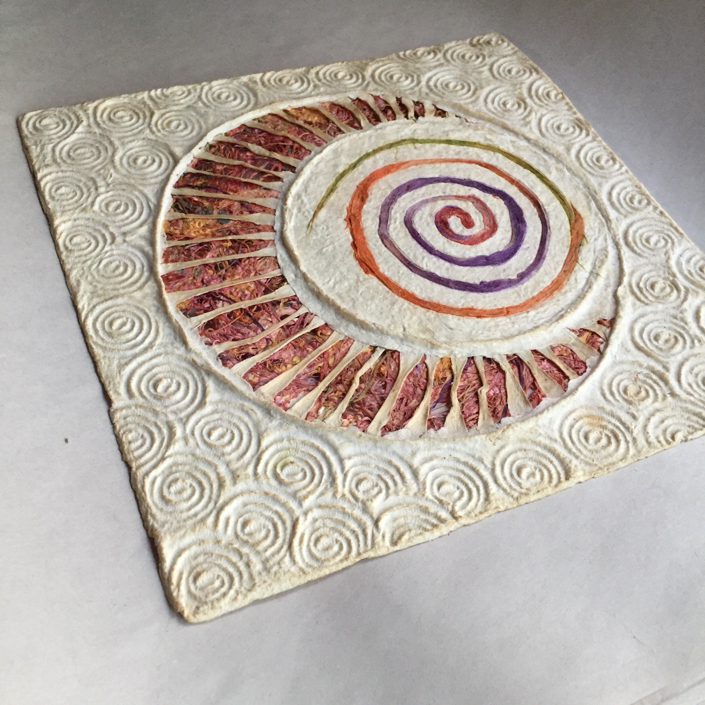 Handmade Amate Paper Wall Art with multicolor woven moon and spiral