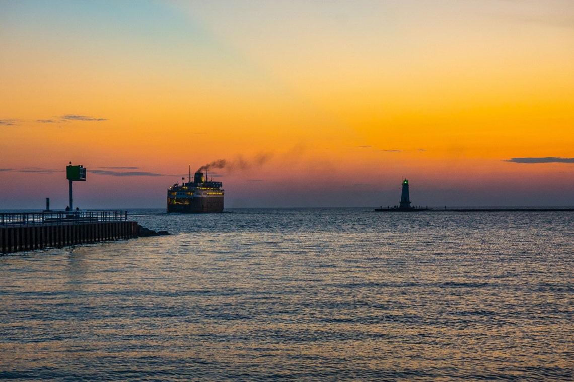 Sunset Ferry on Lake Michigan Passes Lighthouse in Ludington, Michigan ...