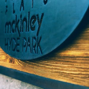Modern Sign From Wood and Metal With Lighting. Polished Metal on the ...
