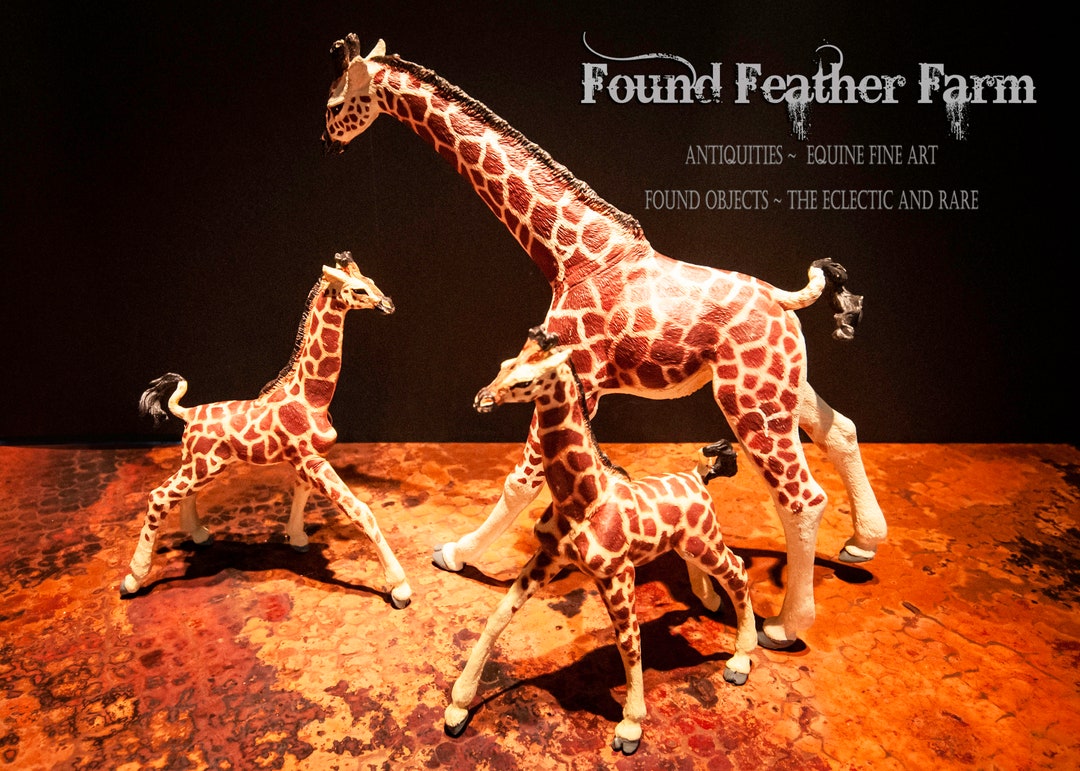 A Resin and Hard Rubber Toy Figurine of a Giraffe Mother and Her Twin ...