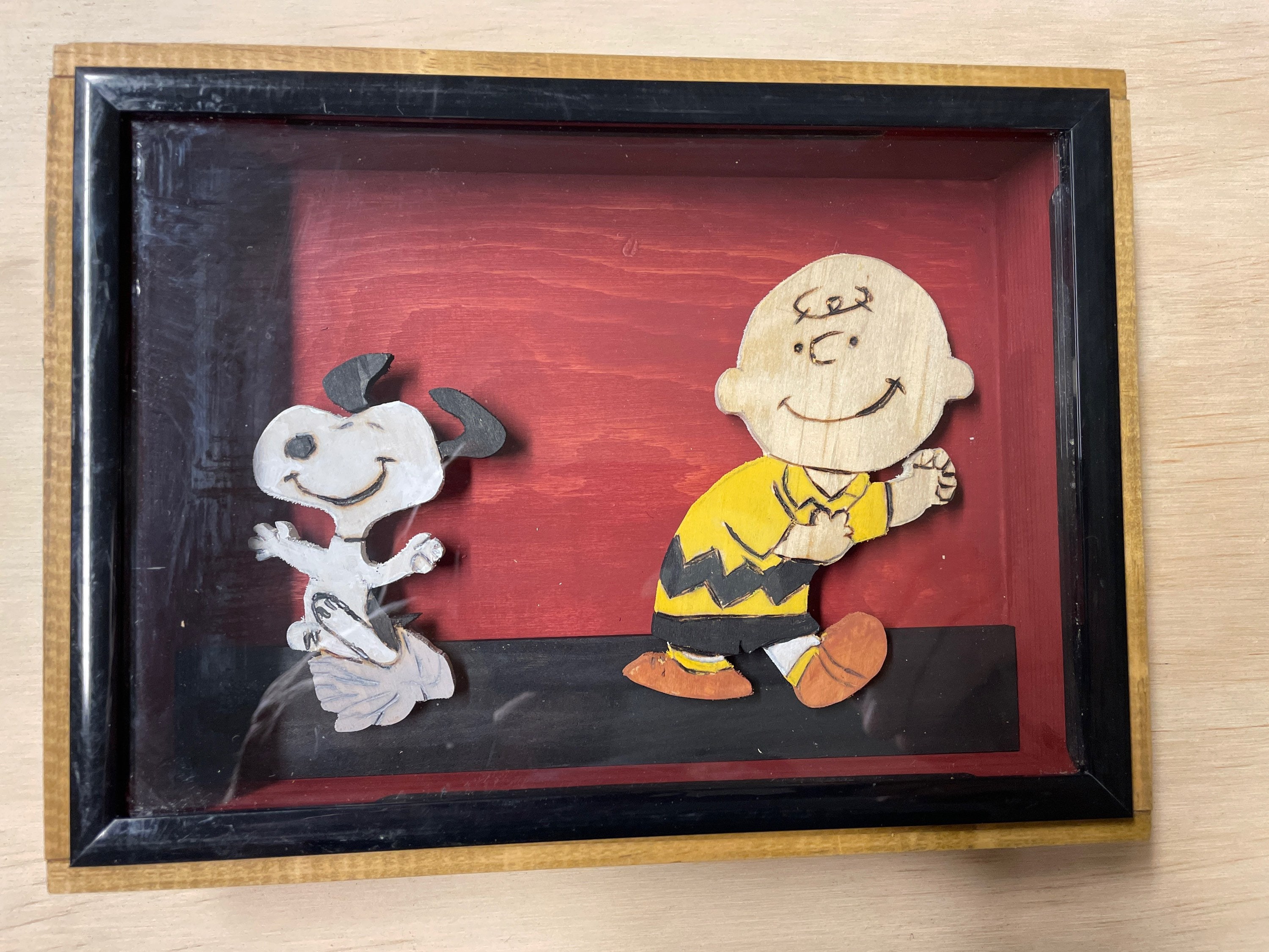 Wooden shadow box of Snoopy and Charlie Brown dancing