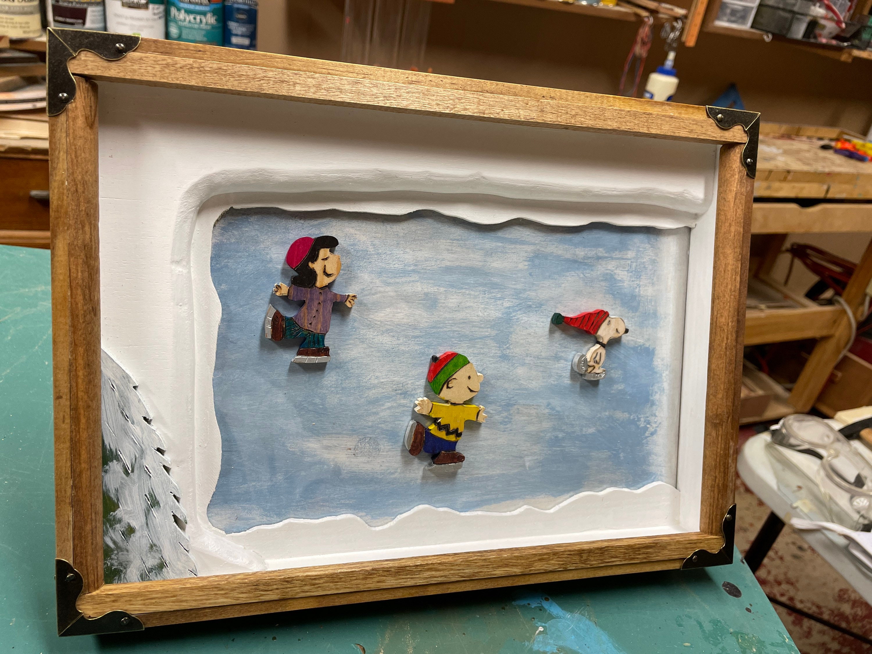 Wooden shadow box of Snoopy and friends skating