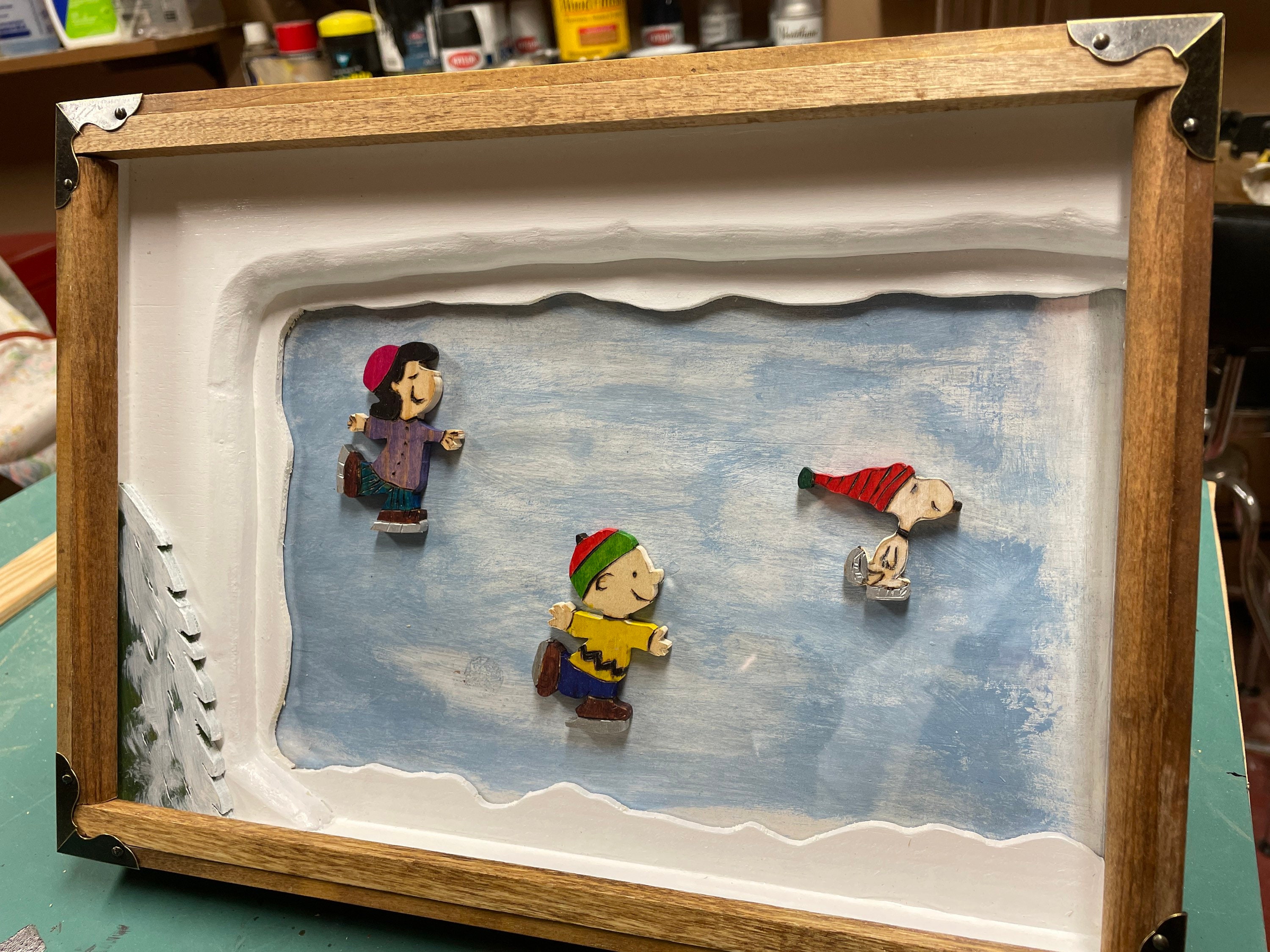 Wooden shadow box of Snoopy and friends skating