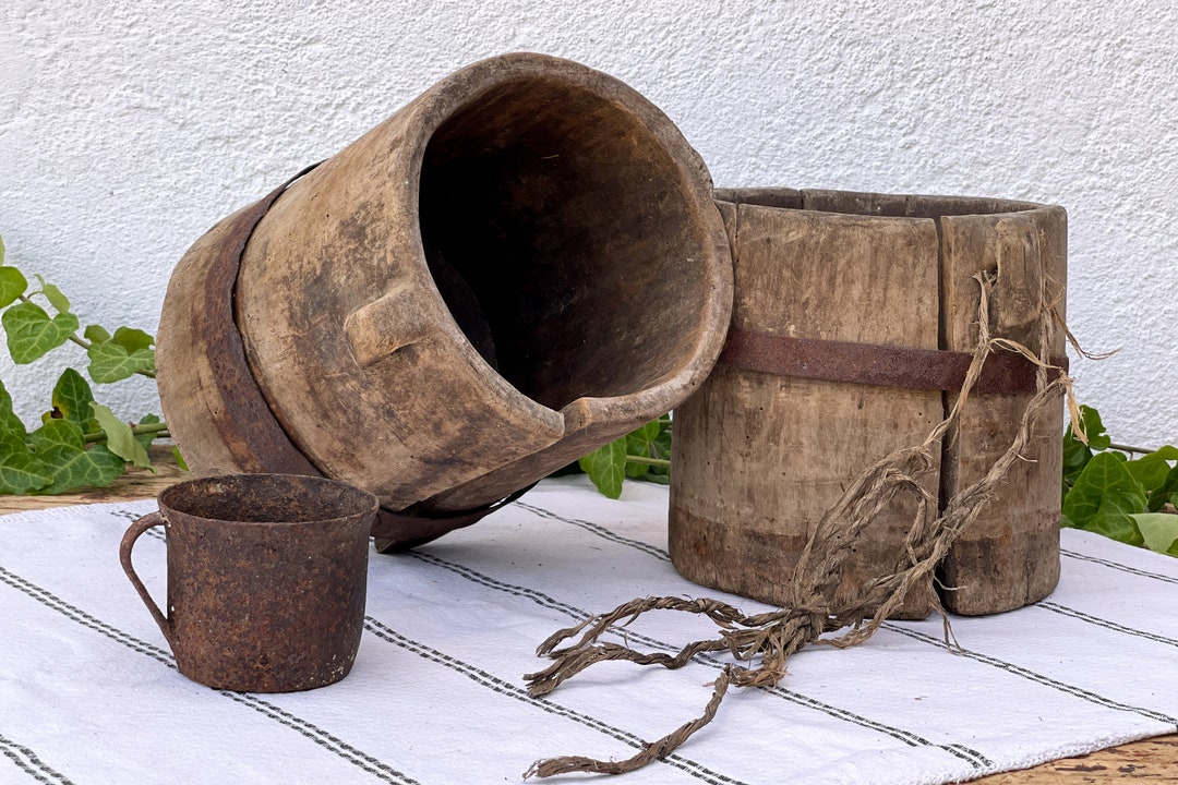 Primitive Wooden Water Buckets Carved Out of Logs and Rusty Metal Cup ...