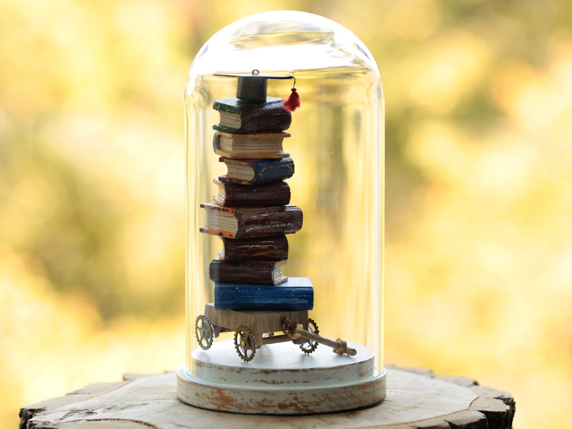 Small wooden sculpture of a book on a cart in glass cloche. An | Etsy