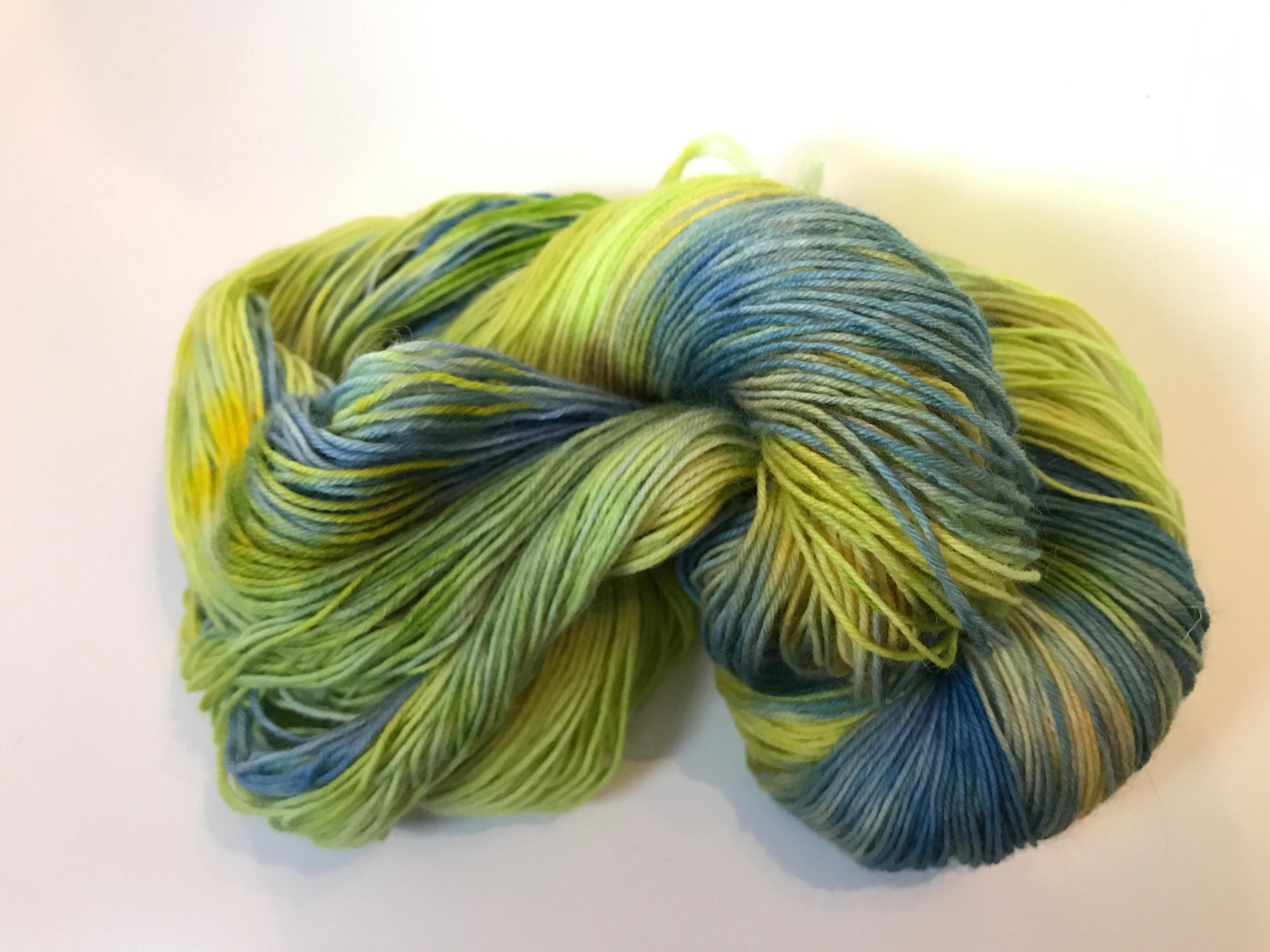 Hand dyed Merino and silk sock yarn in green, yellow and blue.