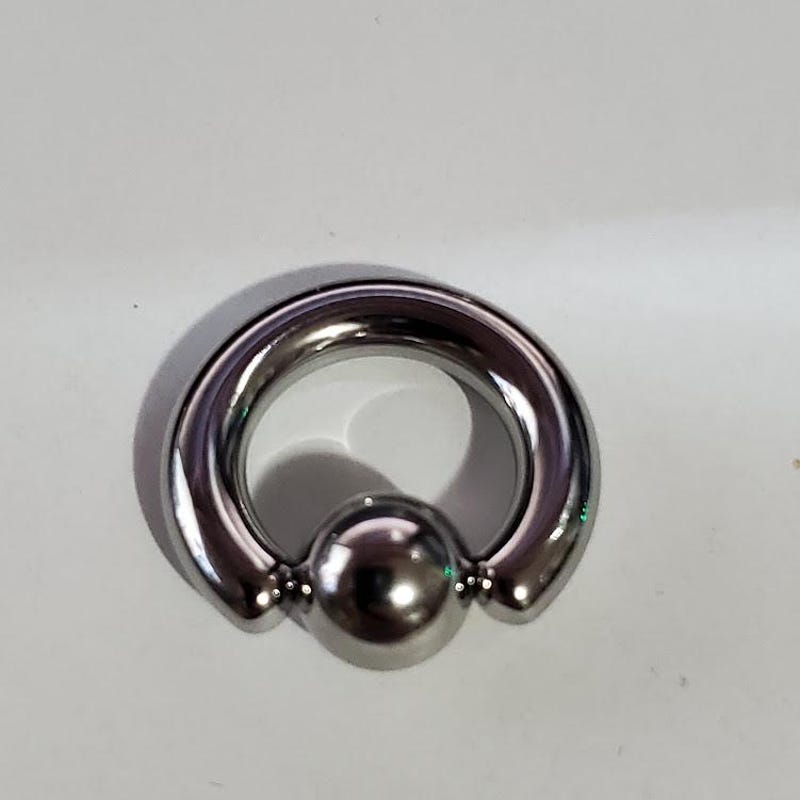 Captive Spring Ball Ring - Etsy