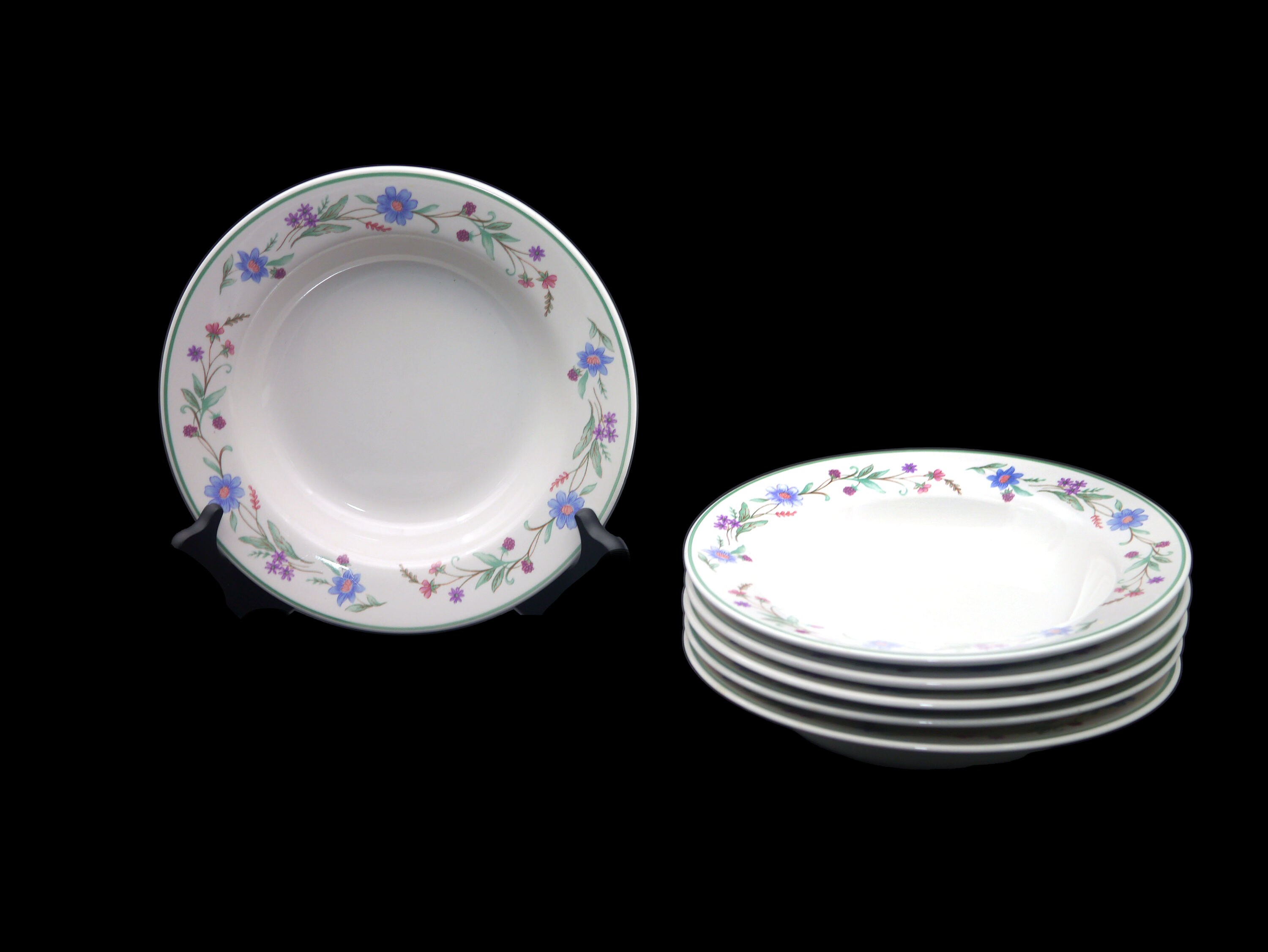 Seven Oneida Ava rimmed soup bowls.