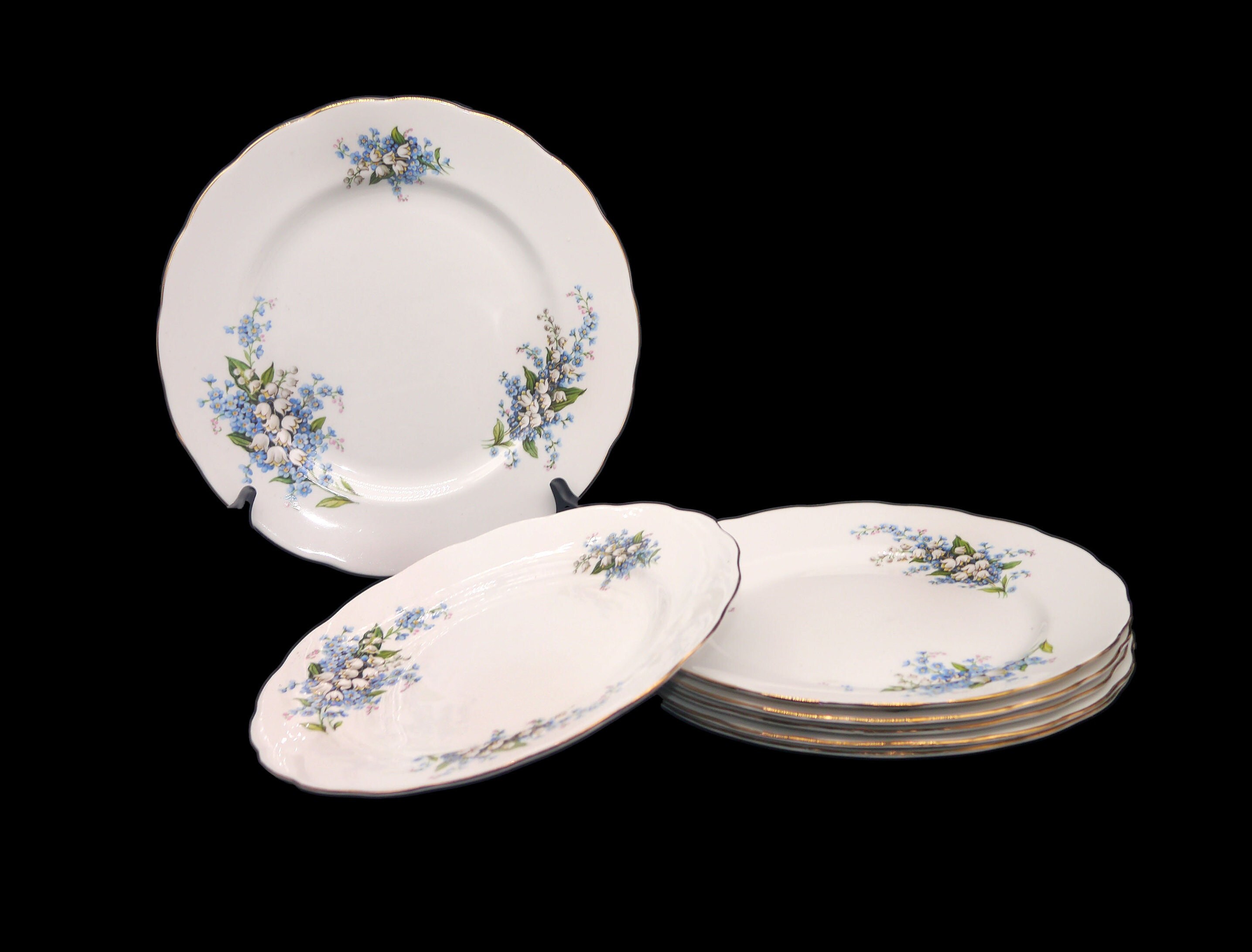 Seven Colclough Forget-Me-Not dinner plates. Bone china made in England.