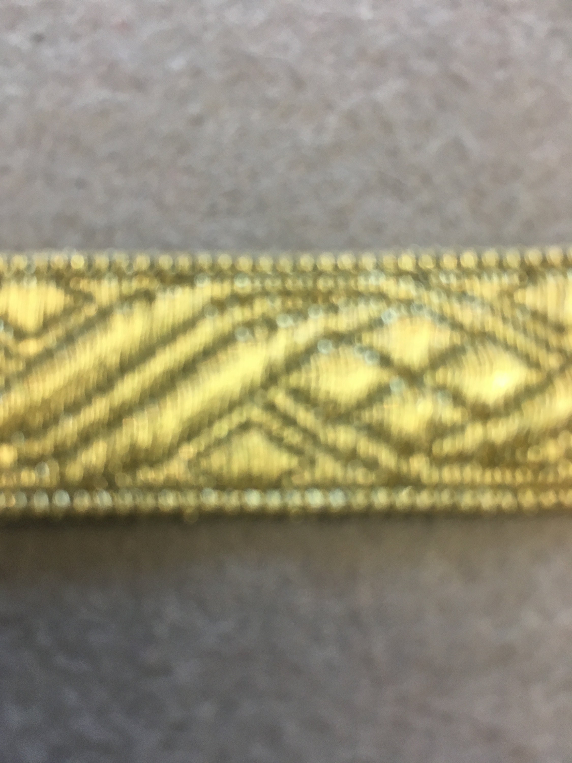 Patterned antique gold flat trim with two straight edges. 13/16 wide ...