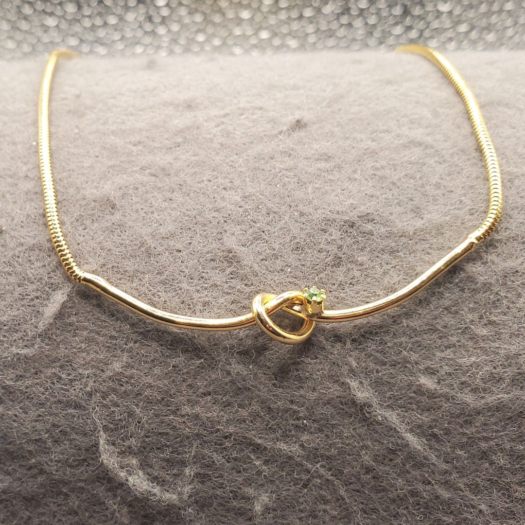 Biagi Short Gold Tone Necklace With a Knot Design and a Green ...
