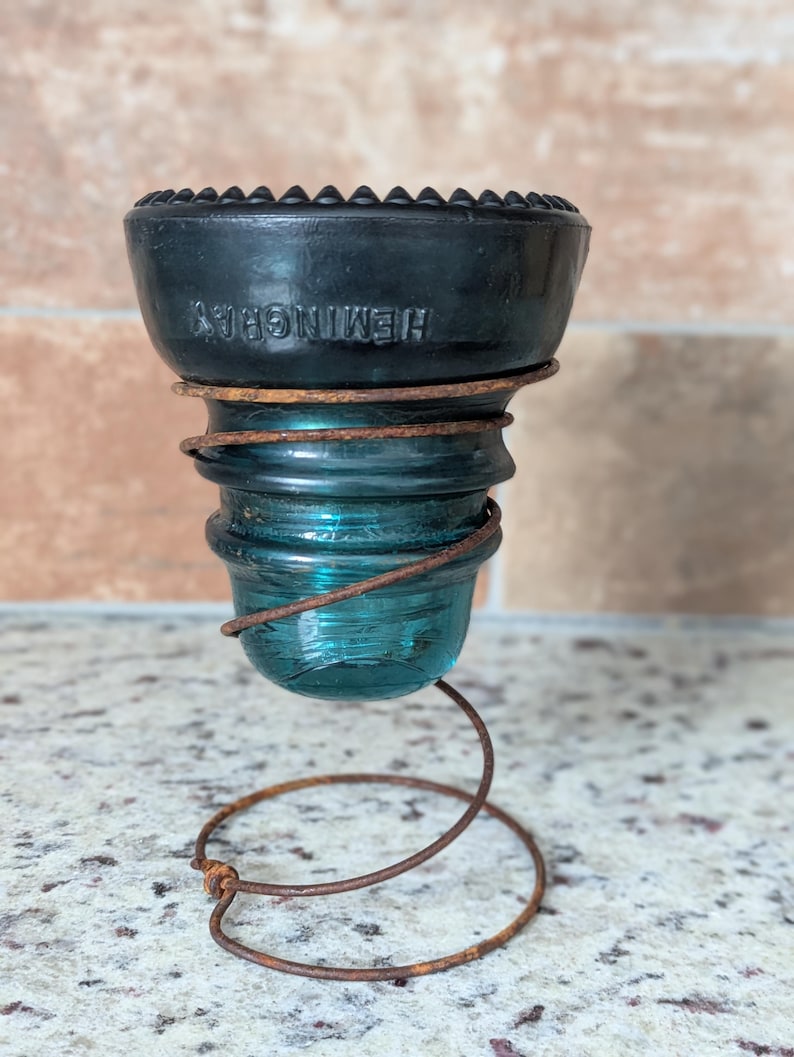 Repurposed Blue Insulator With Rusty Bedspring Holding an Ivory ...