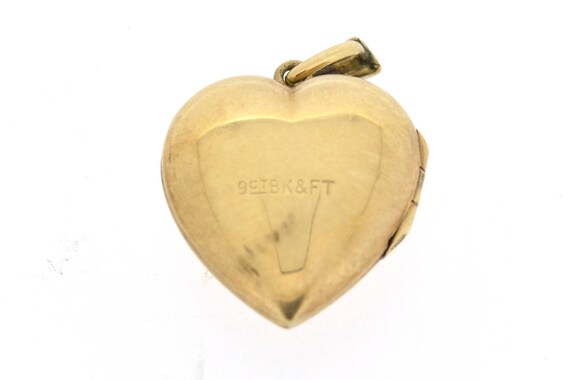 A vintage heart shaped 9ct gold locket. - Gem