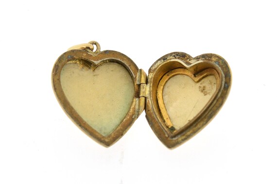 A vintage heart shaped 9ct gold locket. - Gem