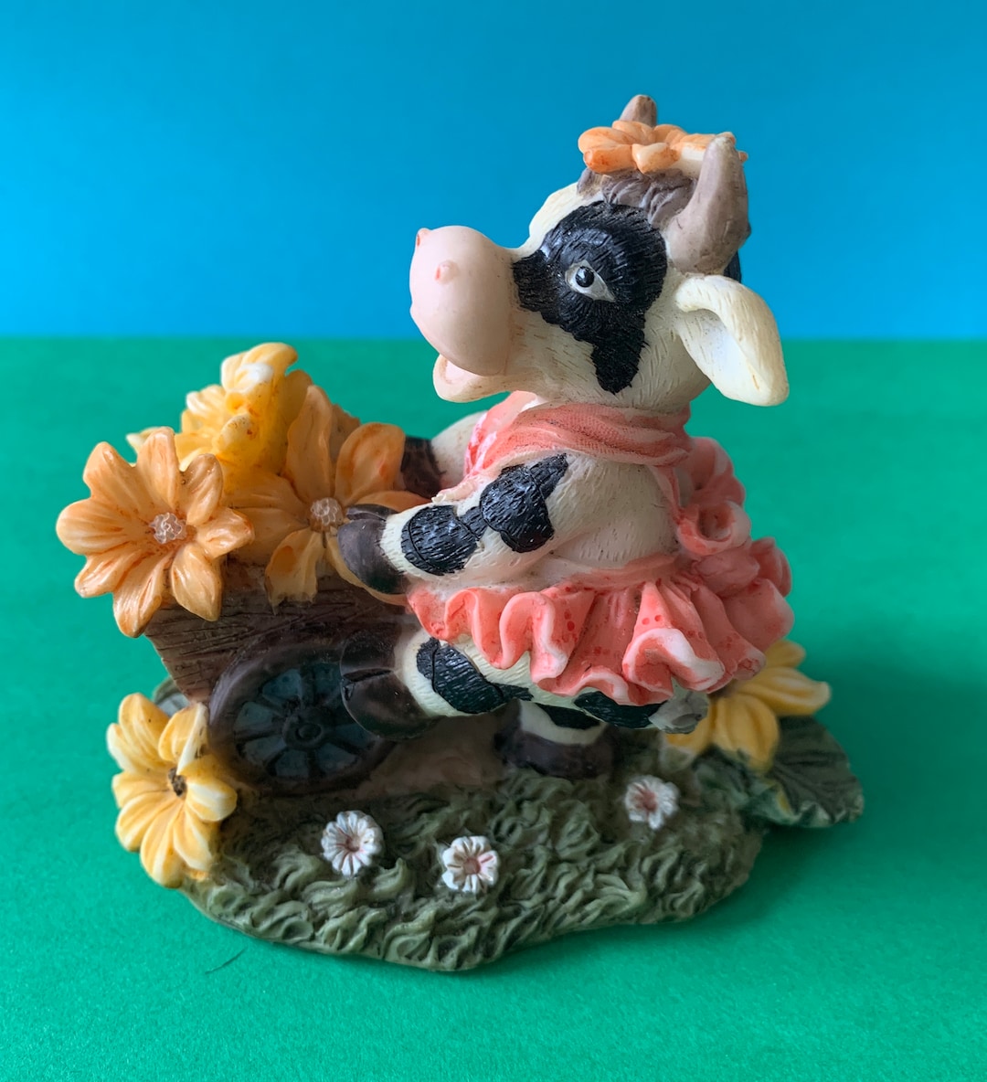 Vintage Cute Cow in a Pink Dress Pushing a Wheelbarrow Full of Yellow ...