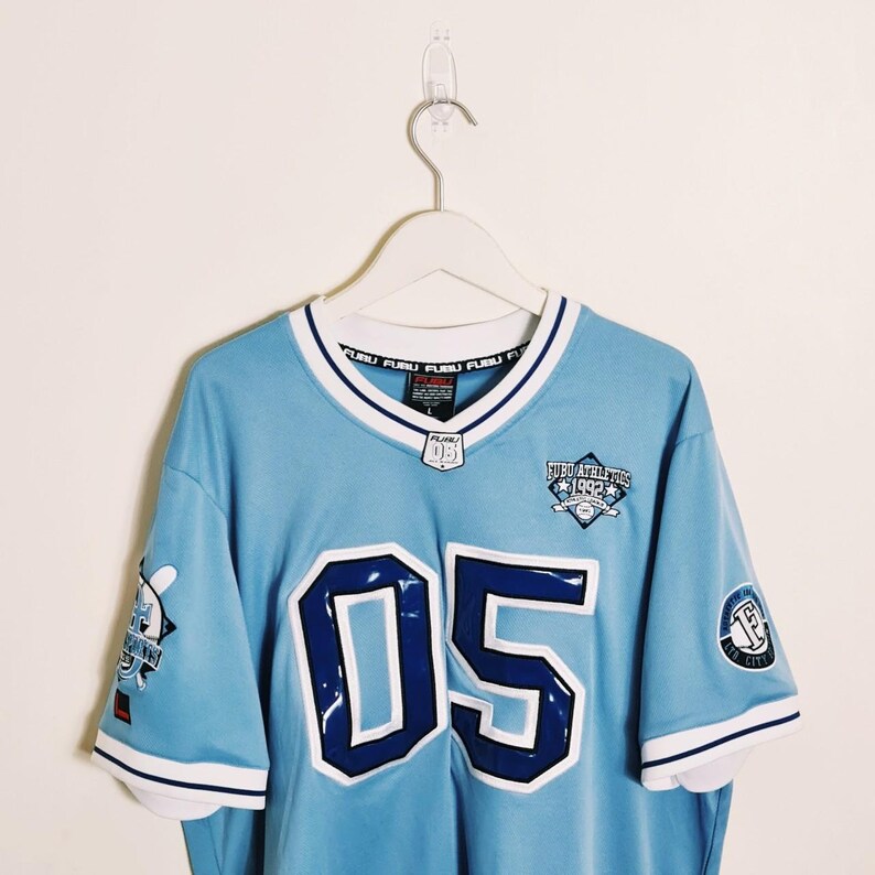 Vintage Y2K 90s 2000s Baby Blue and White Fubu Jersey. Fubu 05 Jersey Top. FUBU ATHLETICS 2005 ...