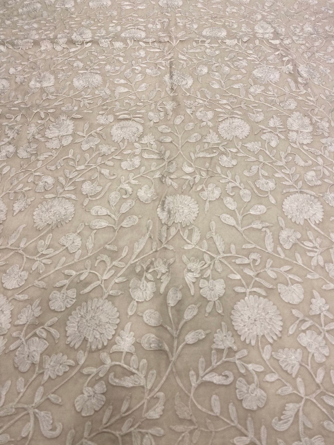 White Woollen Running Fabric With Self Floral Pattern Embroidery ...