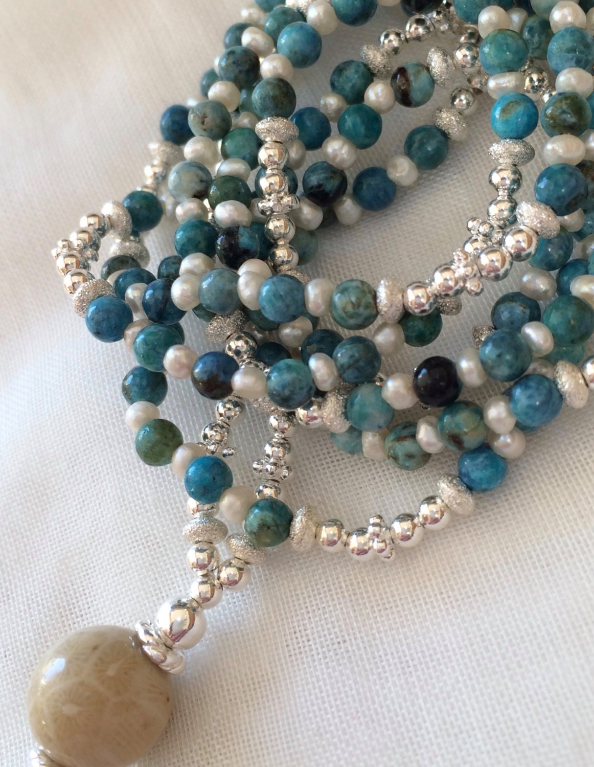 Petite mala made of opalith (blue), decorated with small freshwater ...