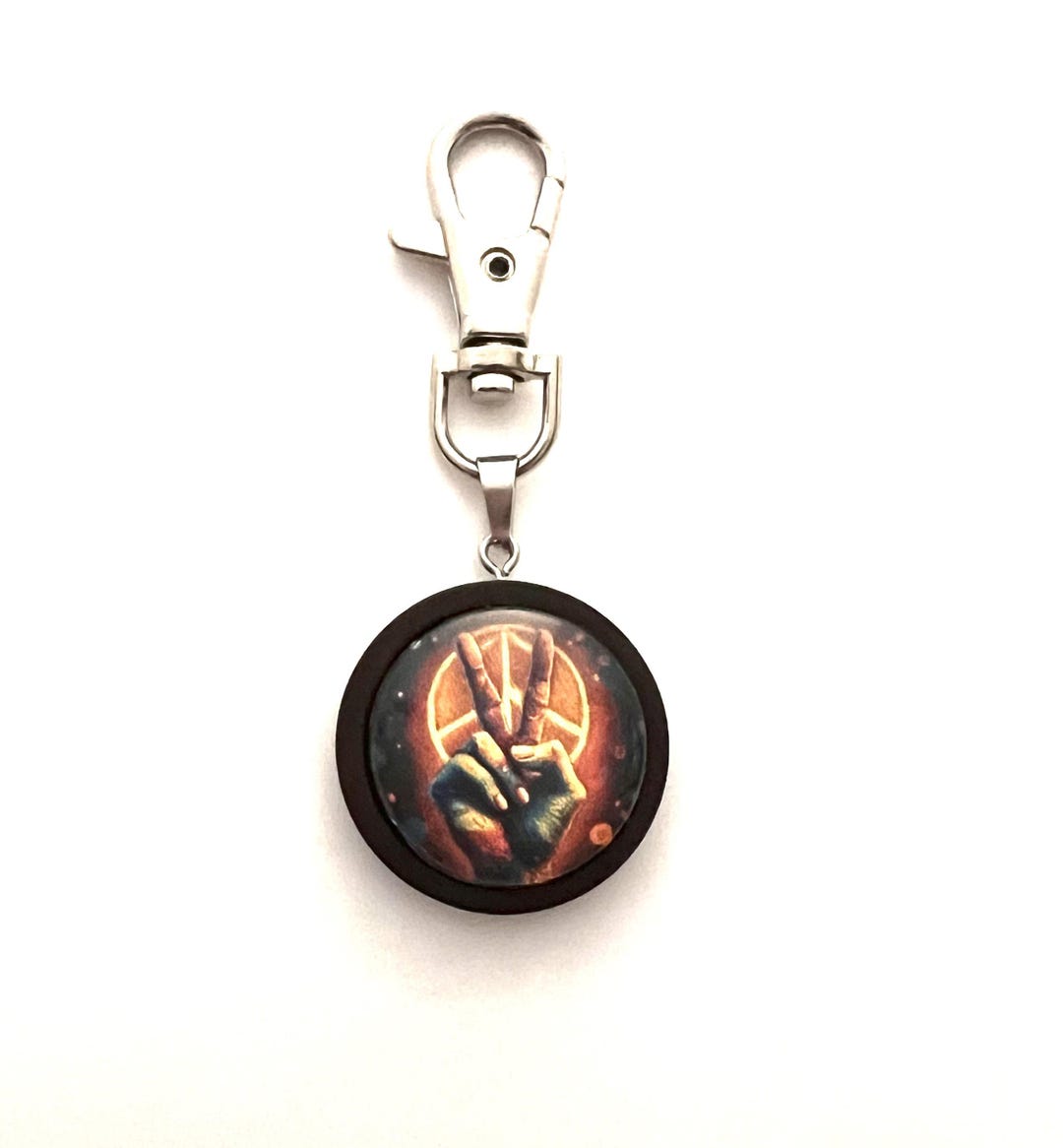 Hand Displaying Peace Sign With Peace Symbol on Dark Brown Wood Pendant ...