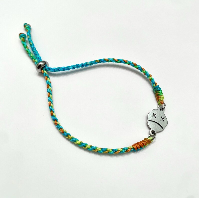 Adjustable Skull Bracelet With Sad Face Charm & Rainbow Colored Cord ...