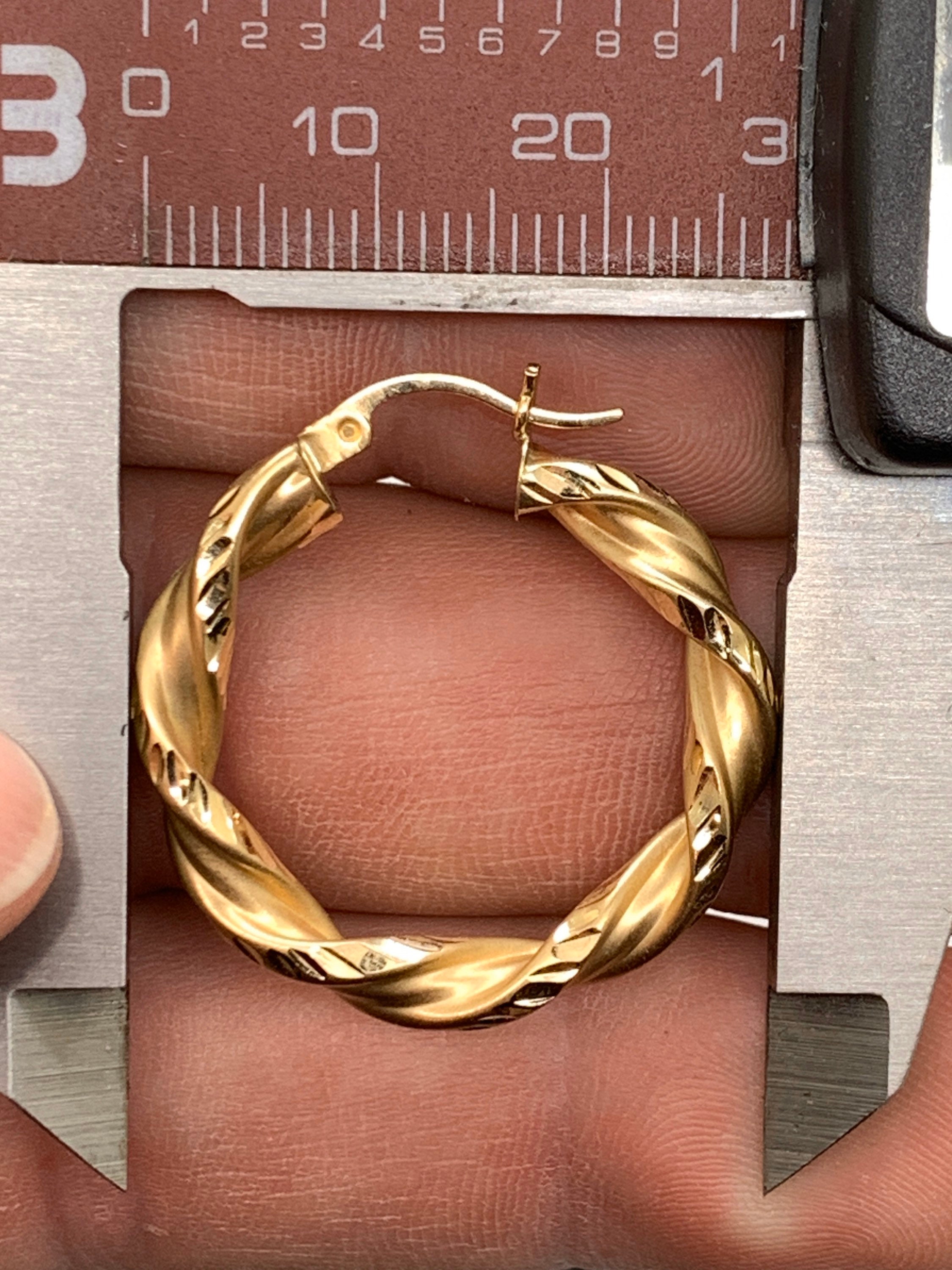 Gorgeous, brushed, and etched 14k gold twisted hoops. 30mm