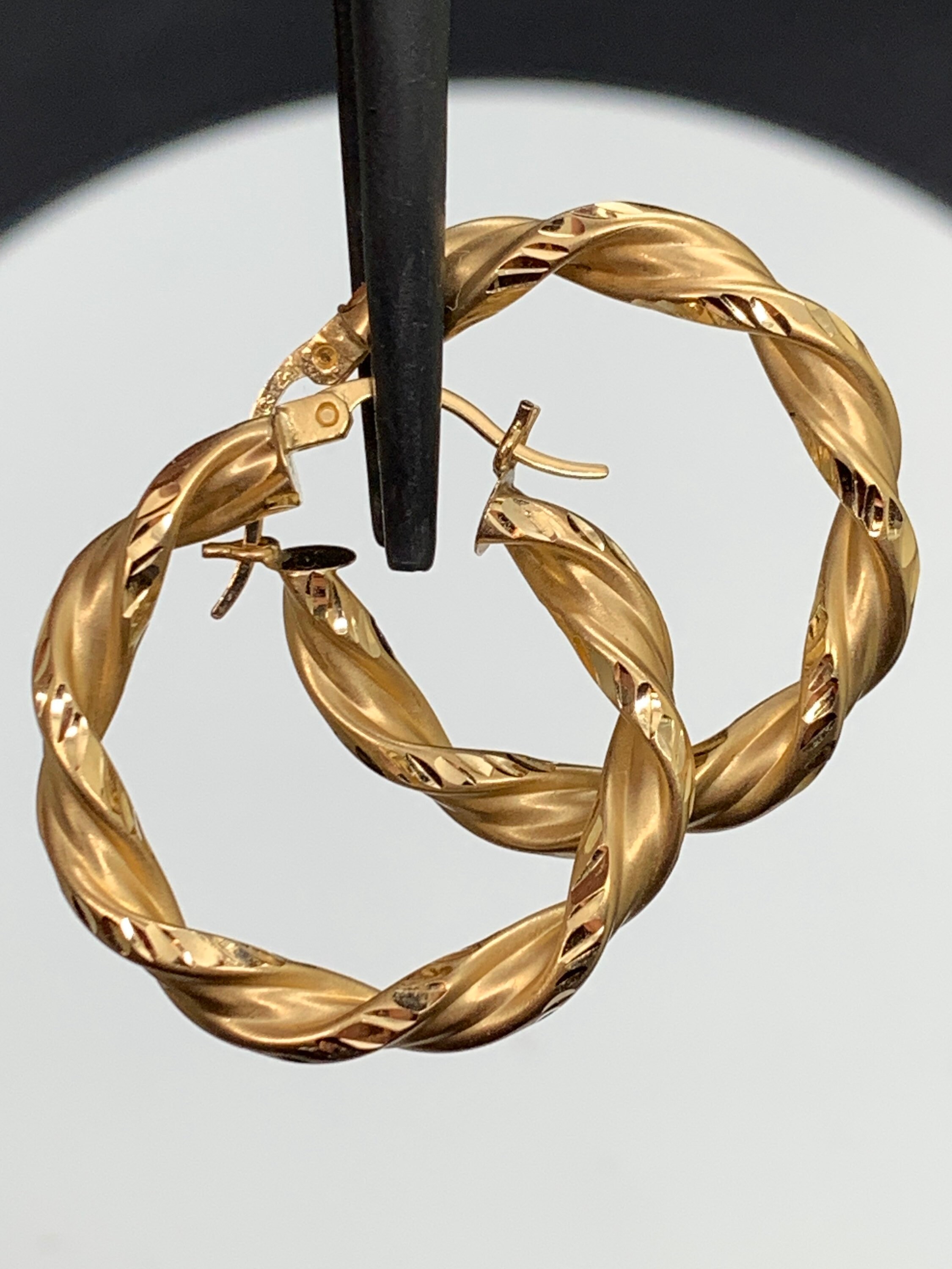 Gorgeous, brushed, and etched 14k gold twisted hoops. 30mm