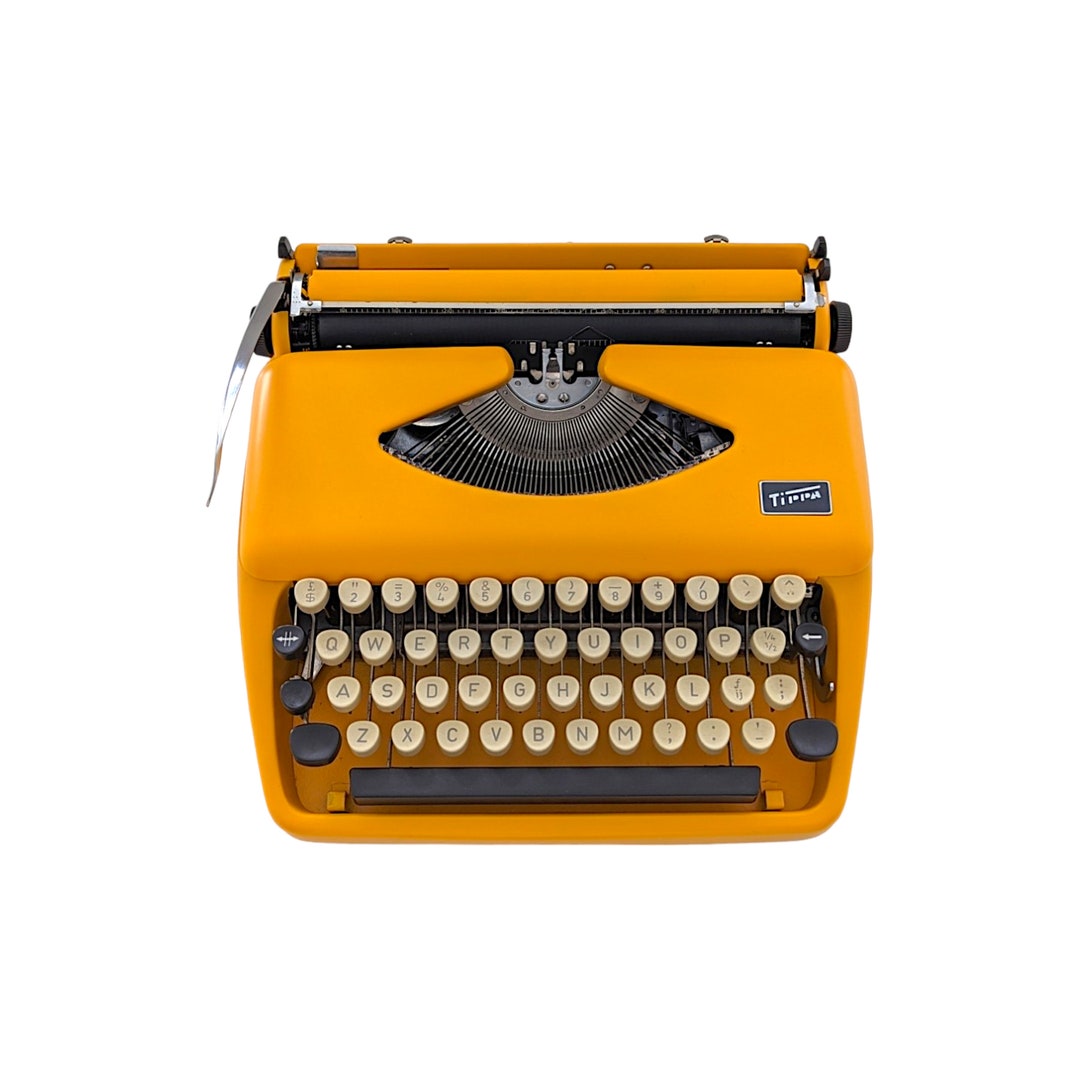 SALE A Vintage Adler Tippa Typewriter, a Smaller Orange Typewriter With ...