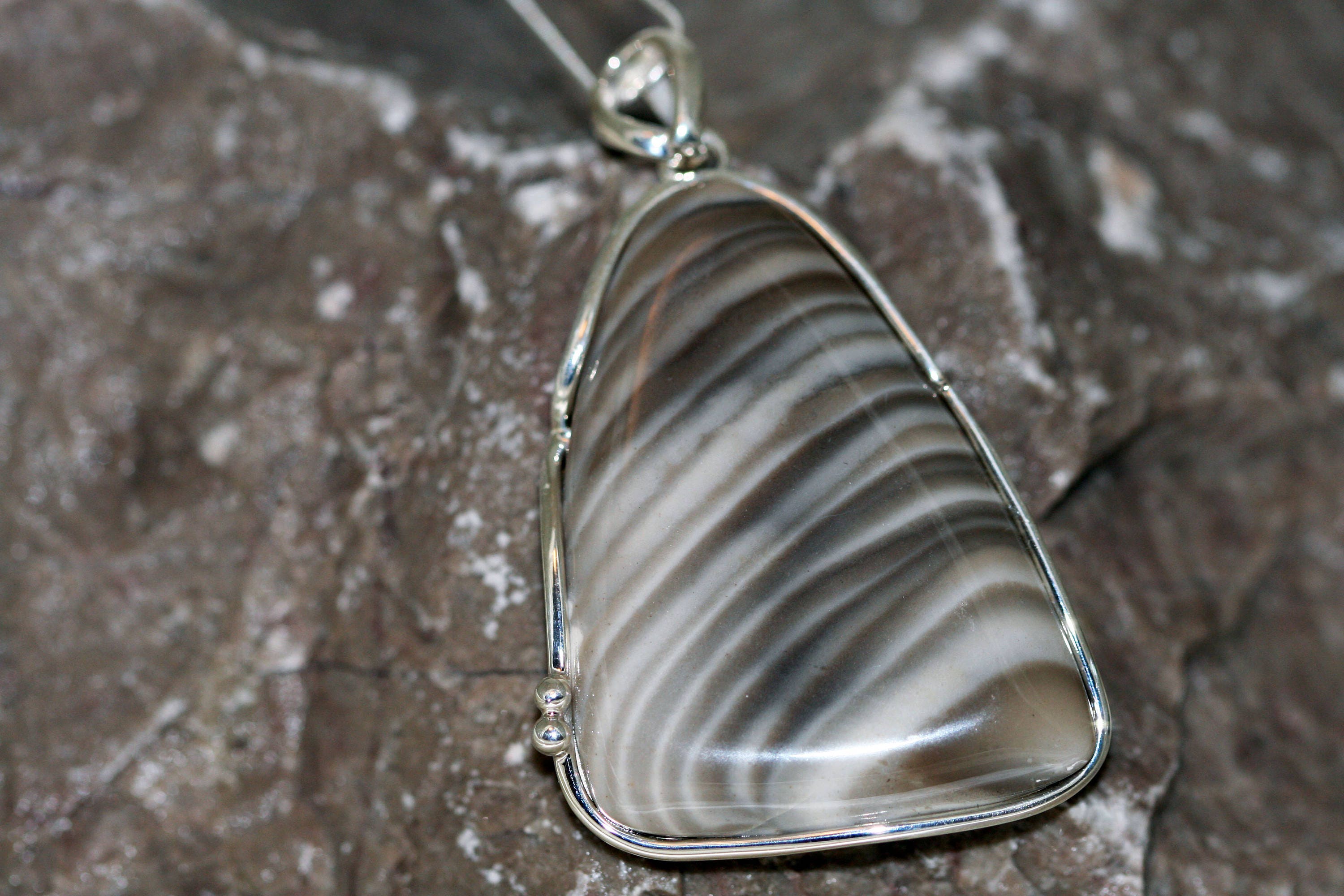 Striped Flint pendant fitted in sterling silver setting.