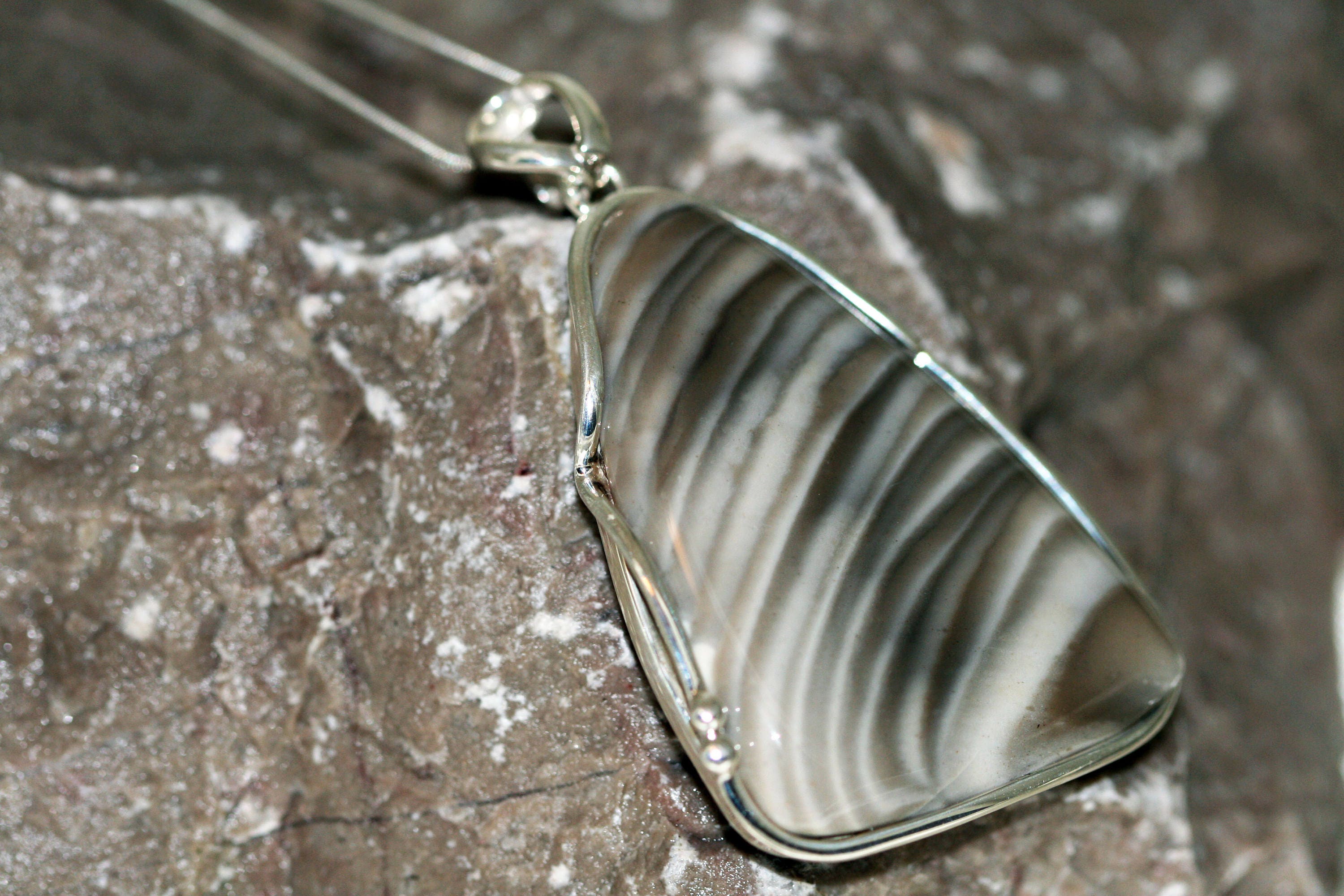 Striped Flint pendant fitted in sterling silver setting.