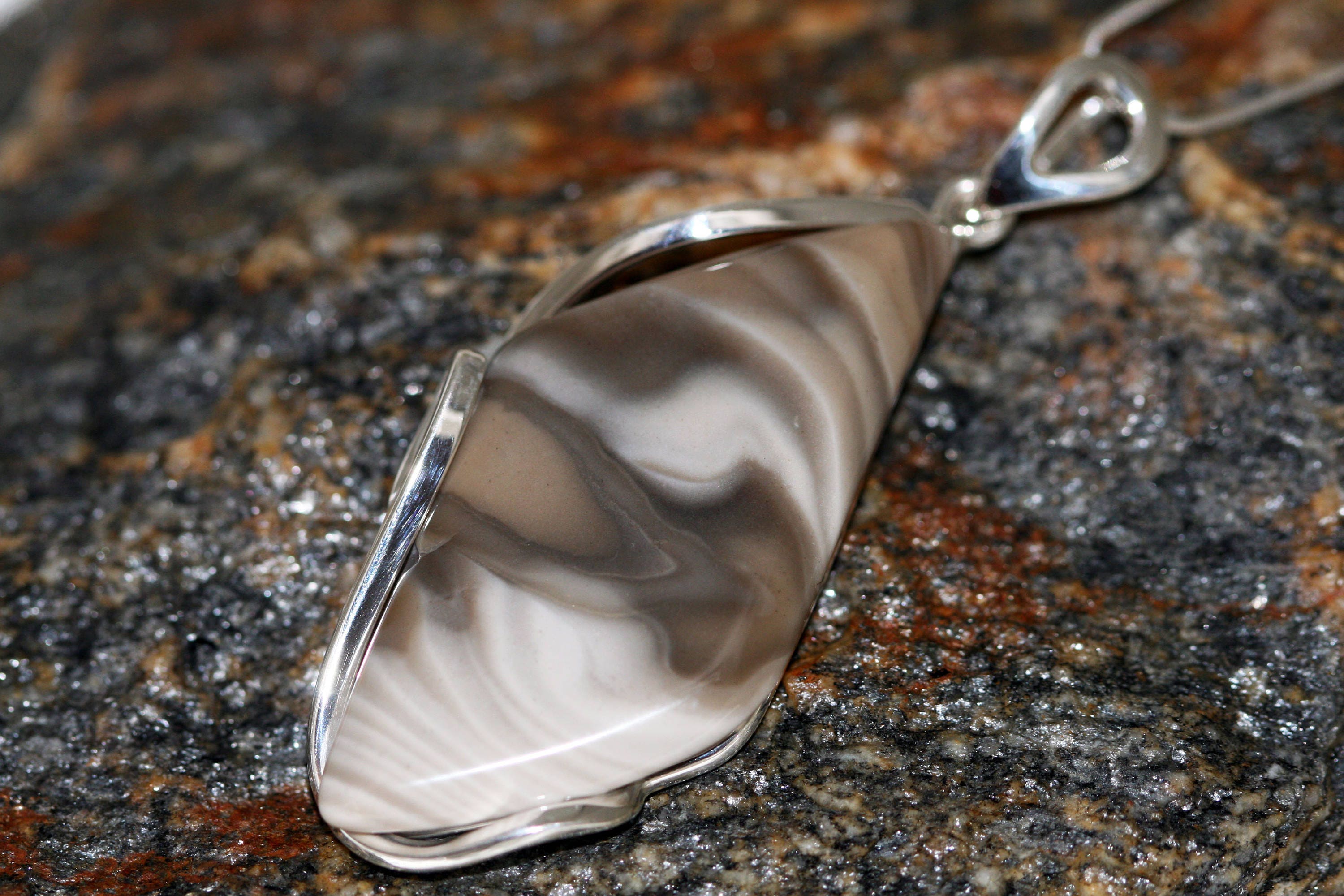 Striped Flint pendant fitted in sterling silver setting.