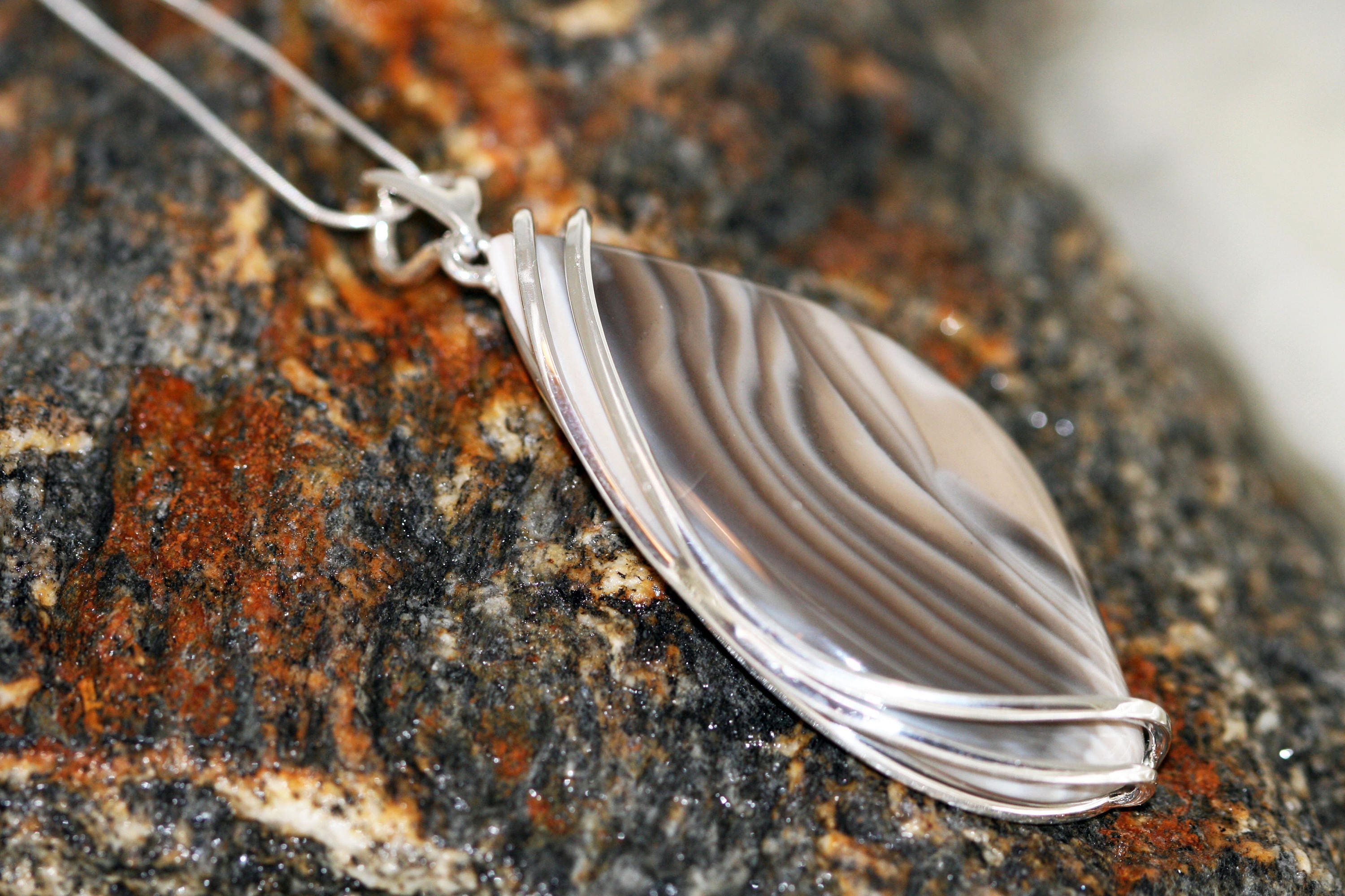 Striped Flint pendant fitted in sterling silver setting.