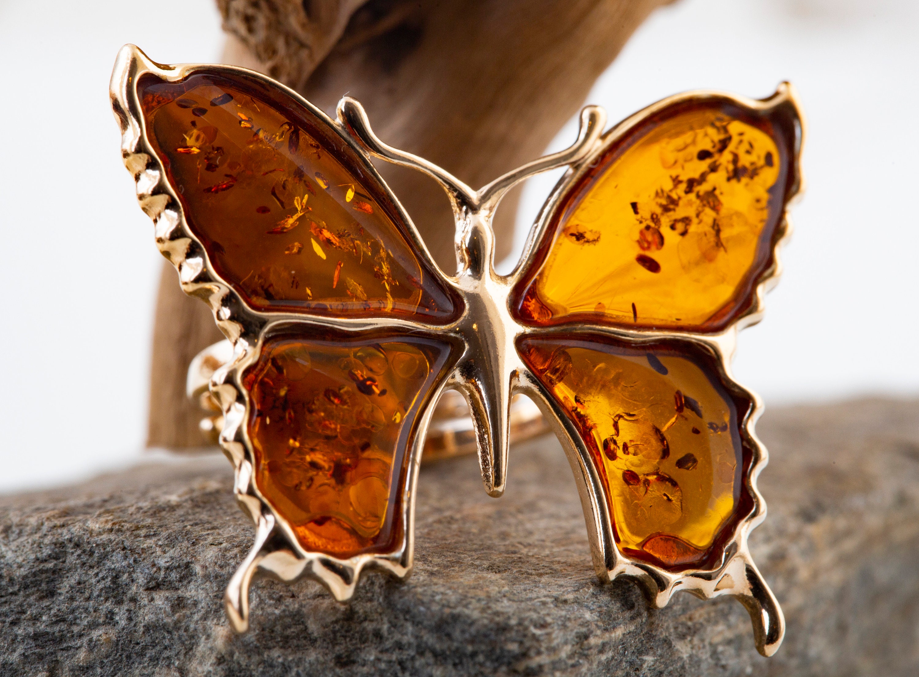 Amber & Gold. Four pieces of cognac Baltic amber. Butterfly shaped ...