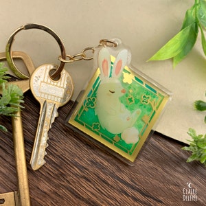 Cute Rabbit Keychain : a Sleeping Bunny in a Gold Frame, With Clovers ...